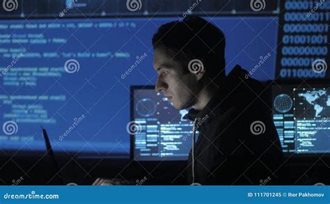 geek hacker programmer is working on computer in cyber security center