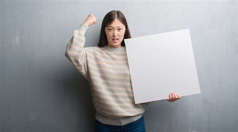 회색 벽 잡고 배너 화가 이상 젊은 중국 여자와 미친과 제기 손으로 소리 분노와 좌절 외치고 분노 개념 감정에 대한 스톡 사진 및 기타 이미지 Istock