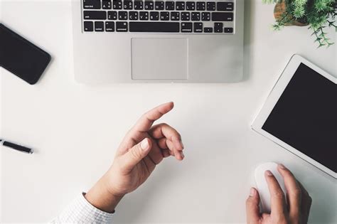 Premium Photo Cropped Hands Of Businessman Holding Computer Mouse On Desk