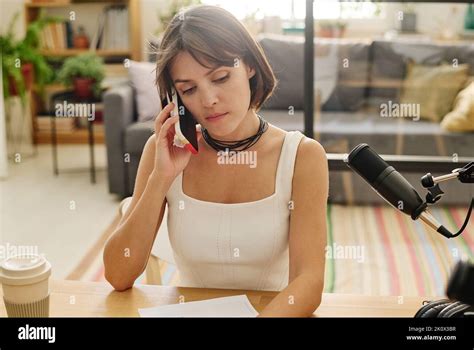 Young Busy Woman With Smartphone By Ear Taking Interview On The Phone