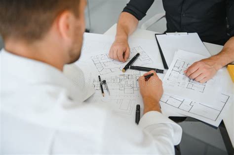 Engineers Are Helping To Design Work On Blueprints And Collaborate On Structural Analyzing Of