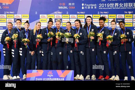 Players Of United States Women S National Volleyball Team Pose With Their Trophy After Winning