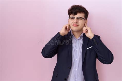 Young Non Binary Man With Beard Wearing Suit And Tie Covering Ears With