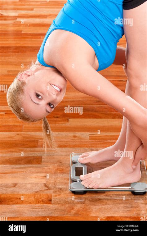 Woman Measuring Her Weight On A Weighing Scale Stock Photo Alamy