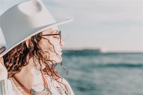 Portrait Of A Curly Haired Woman In A White Hat And Glasses On T Stock