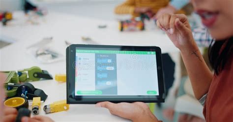 Tablet Hands Of Teacher And Robotics Student Learning In Classroom
