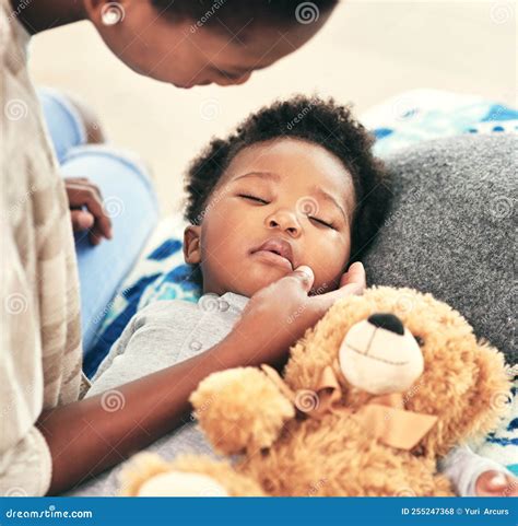 Hes One Special Baby A Mother Putting Her Baby Boy To Sleep Stock