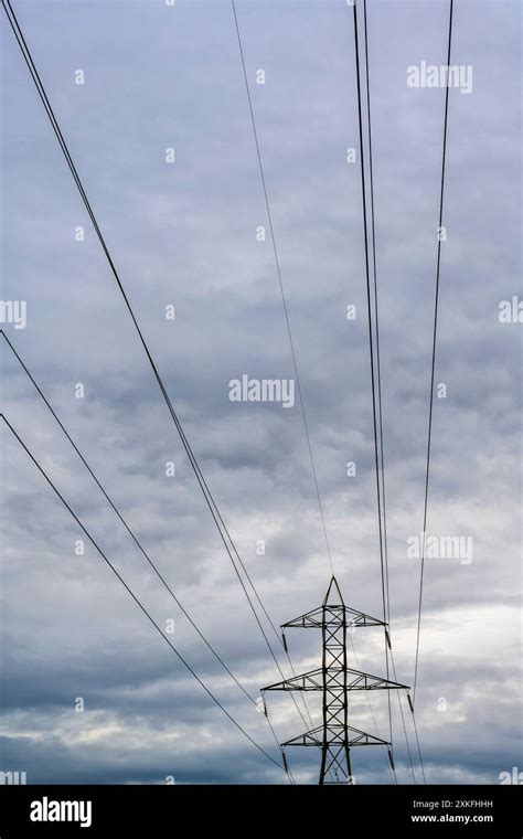 An Electricity Pylon 132kv Overhead Line Pylon Power Lines In Front Of A Cloudy Sky And