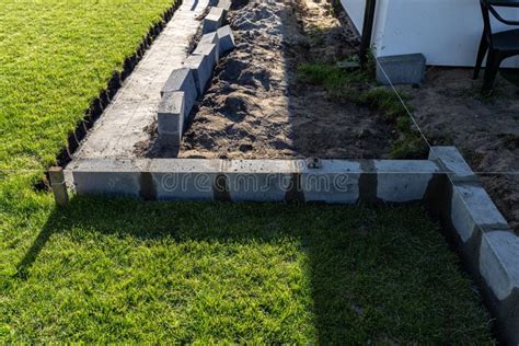 Marking Out Concrete Block Foundations For The Terrace Behind The House Using String Stock