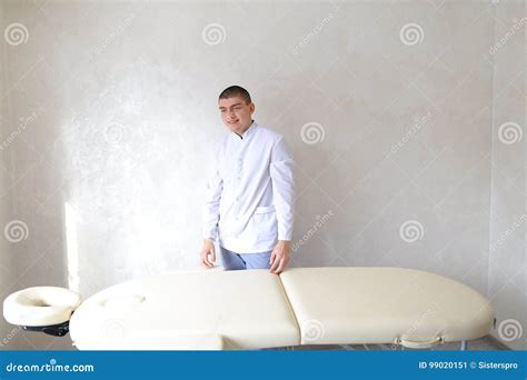 Educated Male Masseur Looks At Camera With Friendly Smile On Fac Stock
