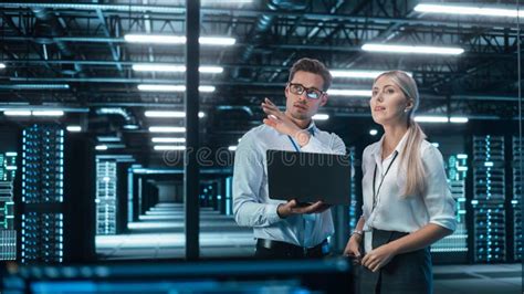 Successful Data Center It Specialist Using Laptop Computer Server Farm