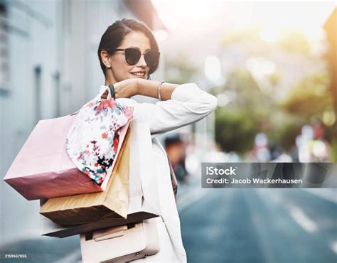 초상화 쇼핑백 또는 부티크 소매 판매 또는 의류를 위해 도시 거리를 걷는 거리의 여성 선글라스 미소 또는 고급 제품과 함께 미소 짓는 도시 도로의 세련된 부자 소녀 고객