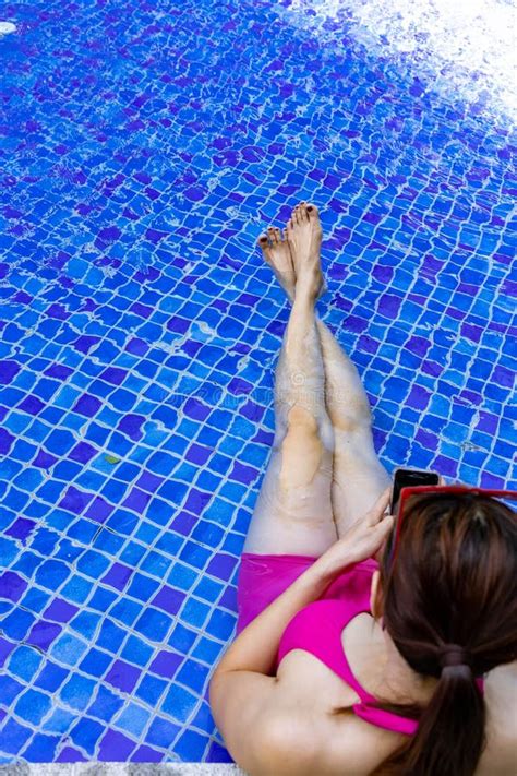 Top View Of A Female While Sitting On Swimming Pool And Using Her Phone Stock Image Image Of