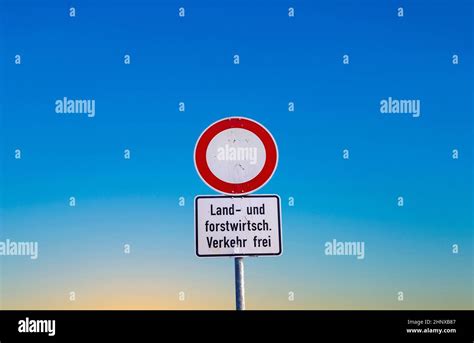 Traffic Sign Tresspassing Forbidden Except Farming Vehicles Under Blue