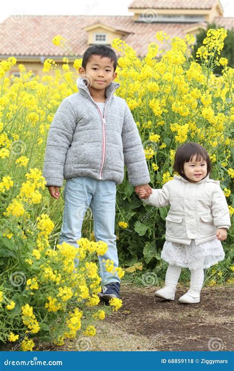 Japanese Brother And Sister Putting Arms Around Each Other`s Sholders