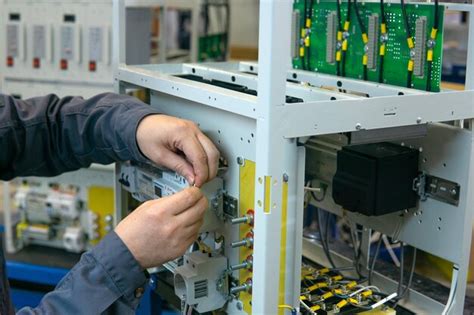 Premium Photo Worker Assembling Electrical Equipment In A Factory
