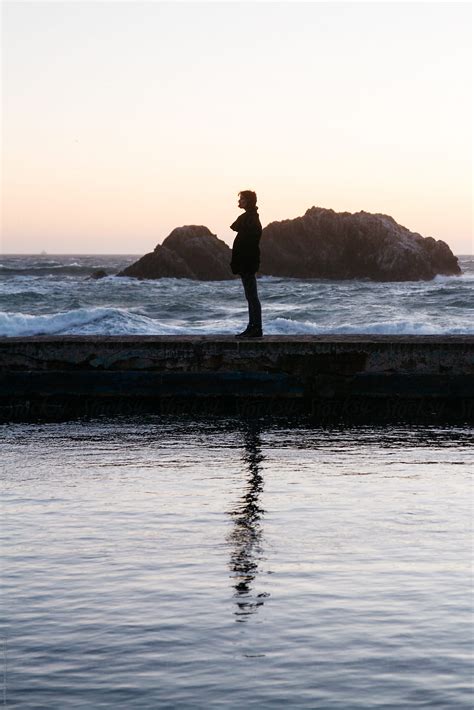 Reflection Of Woman Female At Ocean During Sunset By Stocksy