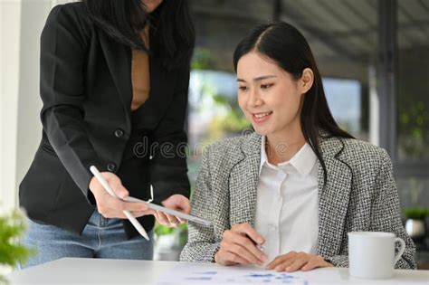 Attractive Asian Businesswoman Working With Her Secretary Checking Her