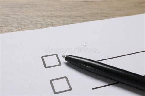 Paper Sheet With Checkboxes And Pen On Wooden Table Closeup Checklist
