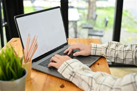 a man using notebook laptop computer typing on keyboard laptop white