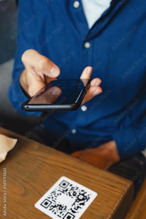 Man Scanning The QR Code With Mobile Phone Stock Photo Adobe Stock