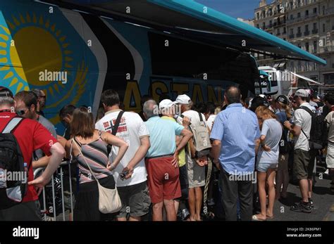 A Crowd Gather Around The Astana Team Bus Before The Start Of The Third