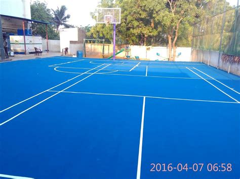 An Outdoor Tennis Court With Blue Tarps And White Lines On The Ground Surrounded By Trees