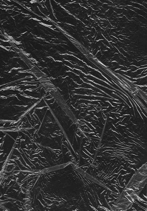 플라스틱 랩 가장자리가 있는 추상적인 검은색 텍스처 · 무료 스톡 사진