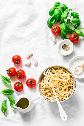 이탈리아 음식 파스타 배경 흰색 배경 상단 보기 복사 공간 향미료 곡물 스파게티 체리 토마토 올리브 오일지중해 스타일 점심 식사에 대 한 재료 평면 배치 건강한 식생활에