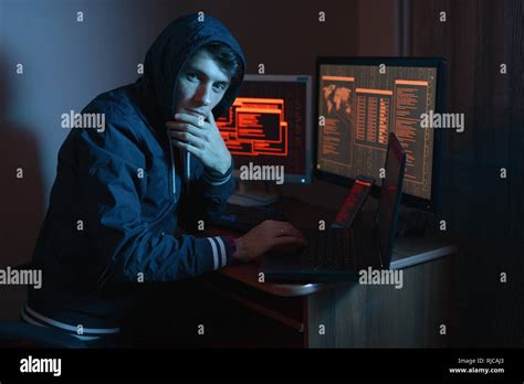 Male In The Hood Looking In The Camera Hacker Attacks And Online Fraud