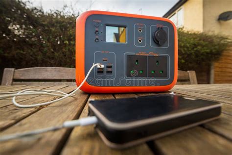 Portable Power Station Solar Electricity Generator With Mobile Phone Plugged In Charging Stock