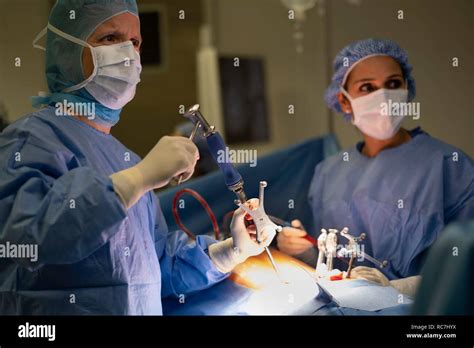 Doctors Performing Spine Surgery Using Neuronavigation Computer