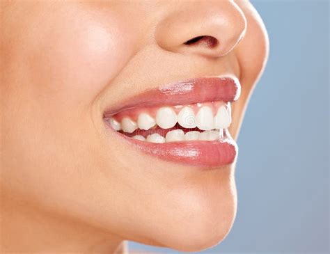 Light Up The Room With Your Smile Studio Shot Of An Unrecognisable Womans Lips Against A Blue