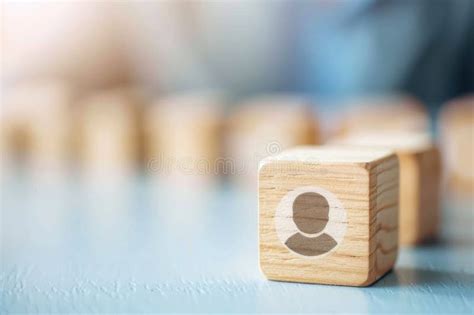 Hand Stacking Wooden Blocks With Icons Representing Teamwork Leadership And Business Strategy
