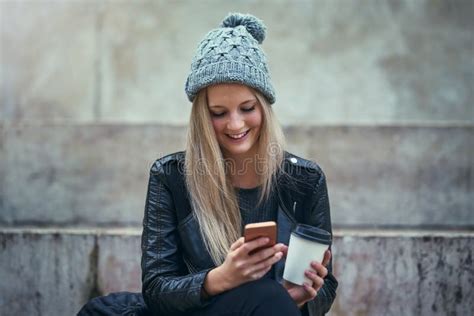 Notifications From Her Favorite Person Make Her Smile An Attractive Woman Using A Mobile Phone