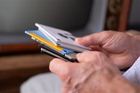 Mature Male Hand Holding Vintage Electronic Data Storage Devices Collection From 80s 90s Disk