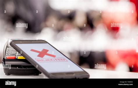 POS Terminal Payment Machine With Mobile Phone On Store Background Contactless Payment With