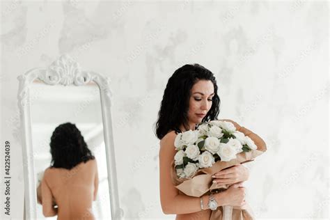 Naked Body Covered With A Bouquet Of Flowers Reflection Of Naked Back In The Mirror Stock Photo