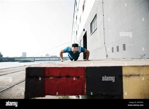 Mature Man Doing Push Ups Outdoors On Loading Dock In Front Of Mature Man Doing Push Ups Outdoors On Loading Dock In Front Of