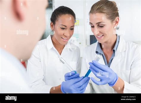Team Of Researchers Doing Experiment In Science Lab Stock Photo Alamy