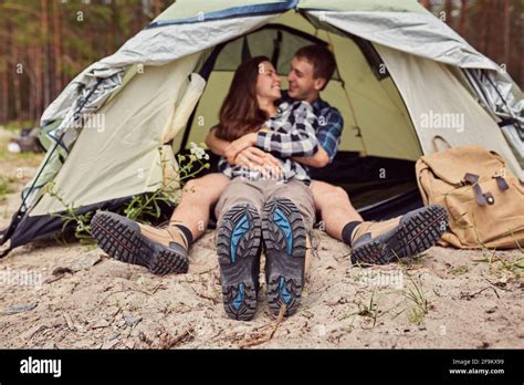 Romantic Couple Camping Outdoors And Sitting In A Tent Happy Man And