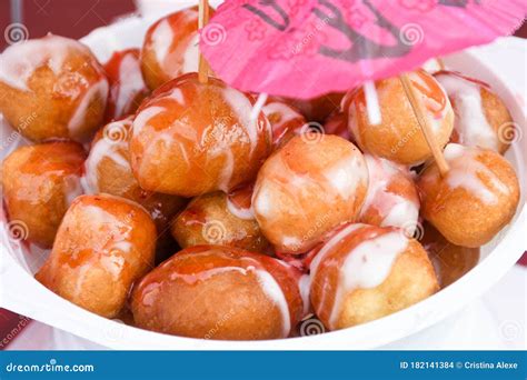 Fresh Round Small Donuts During Carnival Or Fast Food Festival Glazed With Dark And White