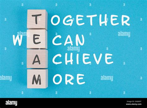 team together we can achieve more is standing on wooden cubes