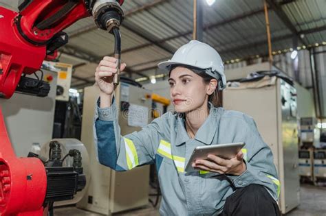 Engineers Woman Maintenance Robotic Arm Female Technician Industrial Checking Robot Machine