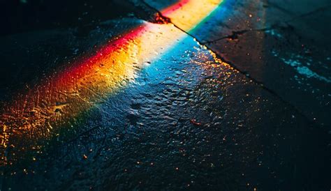 Premium Photo A Rainbow Is Reflected On A Wet Concrete Floor