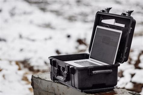 Premium Photo Opened Plastic Protector Case With Laptop Lying On A Construction Site