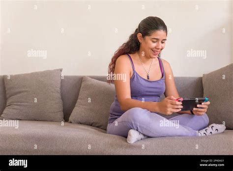 Venezuelan Latin Adult Female Gaming Portable Video Game Holding Joystick Controller Stock