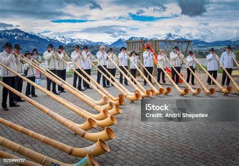 Ensemble Of Swiss Alphorn Blowers Are Playing Outdoor For Everyone