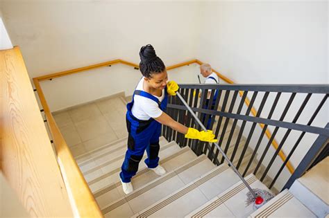 Highangle View Of An Female Janitor Black Ethnicity And Senior Male