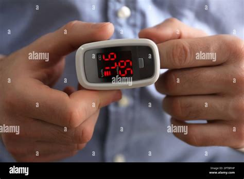 Man Measuring Oxygen Level With Modern Fingertip Pulse Oximeter Closeup Stock Photo Alamy